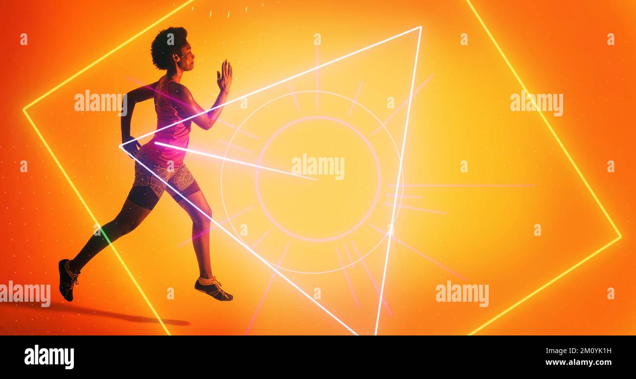 Side view of biracial female athlete running by illuminated geometric ...