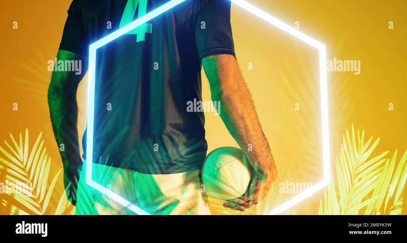 Midsection of caucasian rugby player wearing 4 number jersey with ball ...