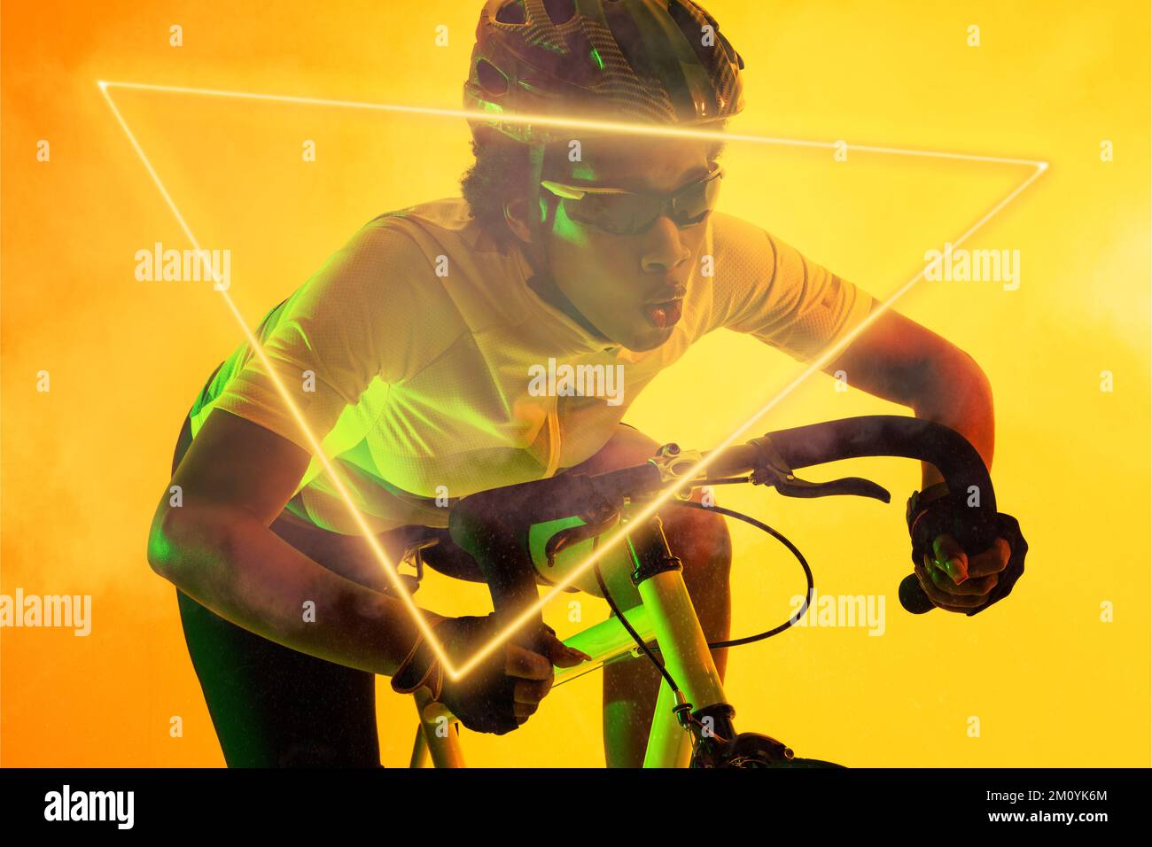Triangle neon over determined african american cyclist riding bicycle ...