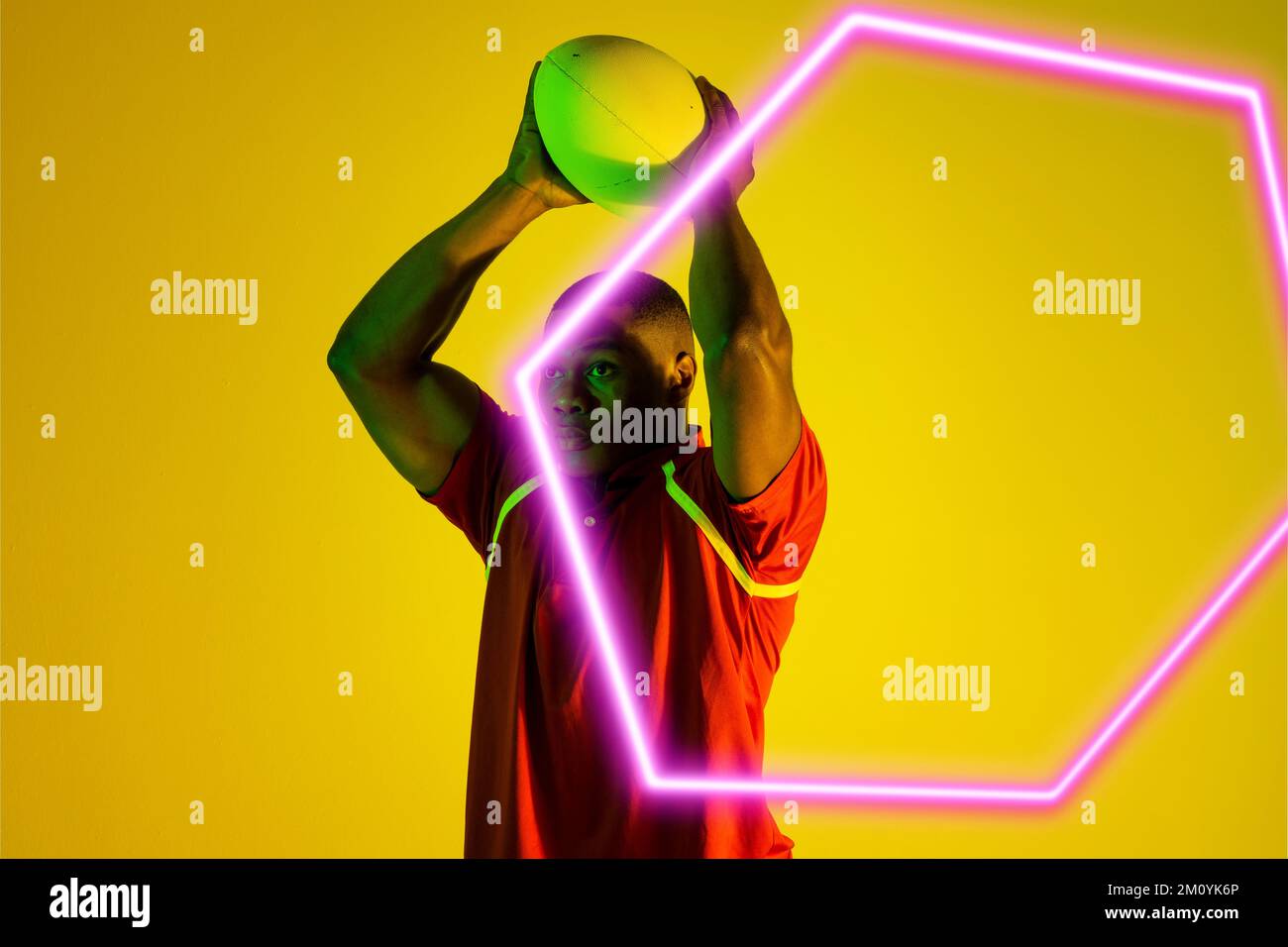Hexagon neon over african american young rugby player playing against ...