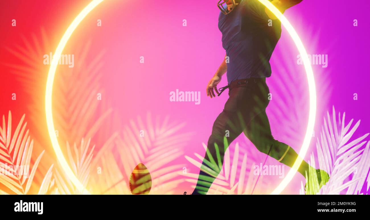 Midsection of african american kicking ball by illuminated circle and ...