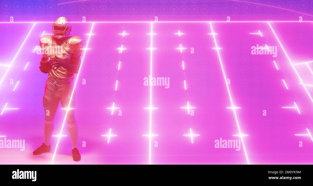 Composite of illuminated american football field and player with ball ...
