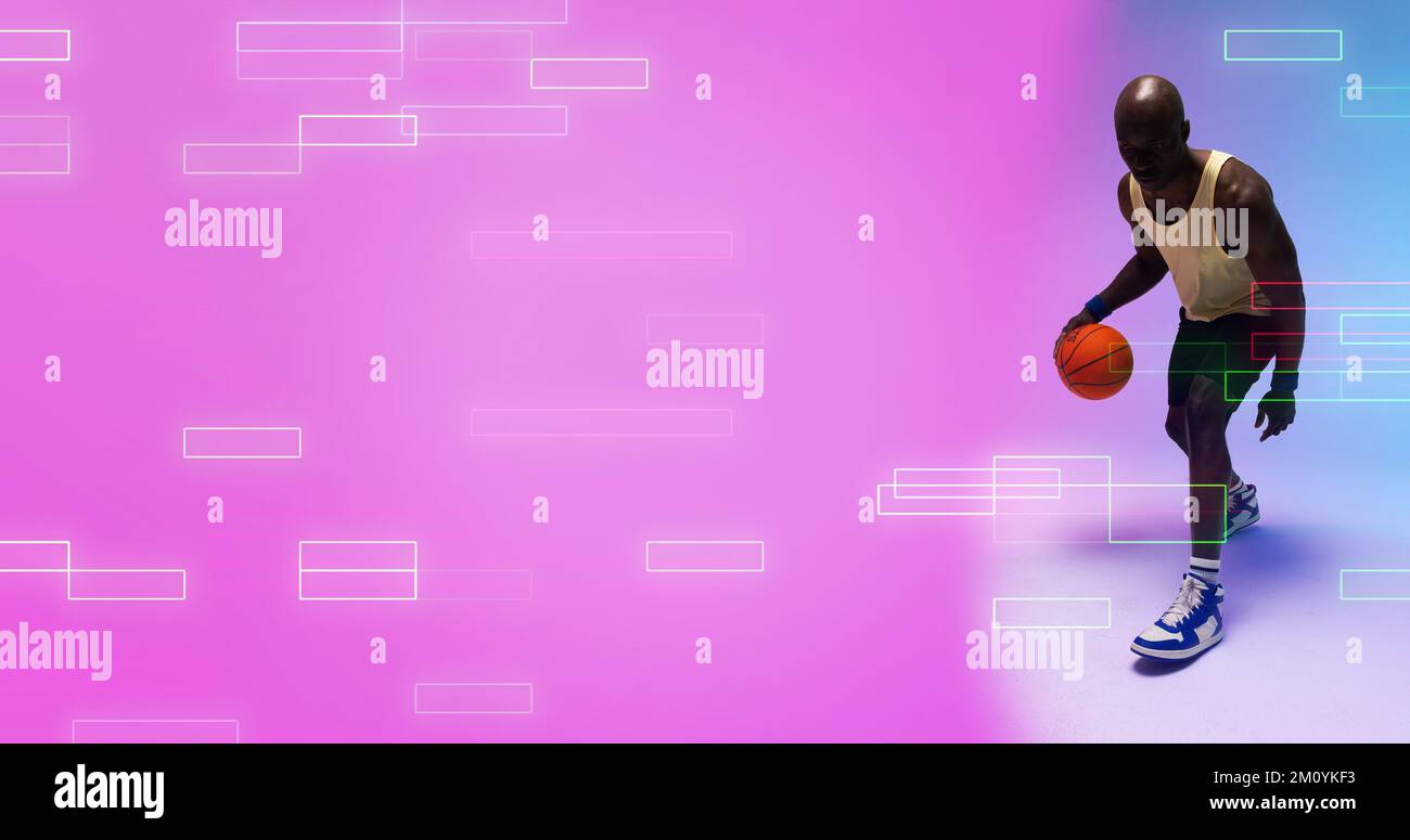 African american bald basketball player dribbling ball with illuminated ...