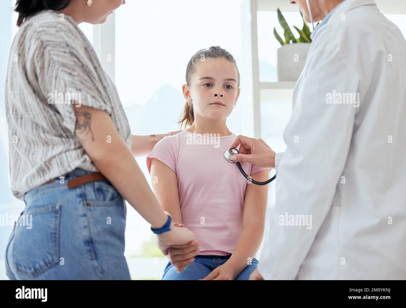 Breathe in and out. a little girl getting a checkup at a hospital Stock ...