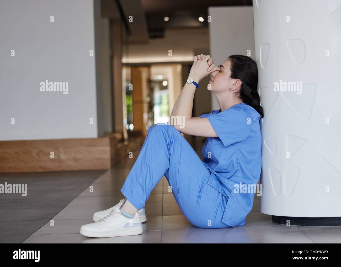 I just need a minute. a young female doctor looking tired while working ...