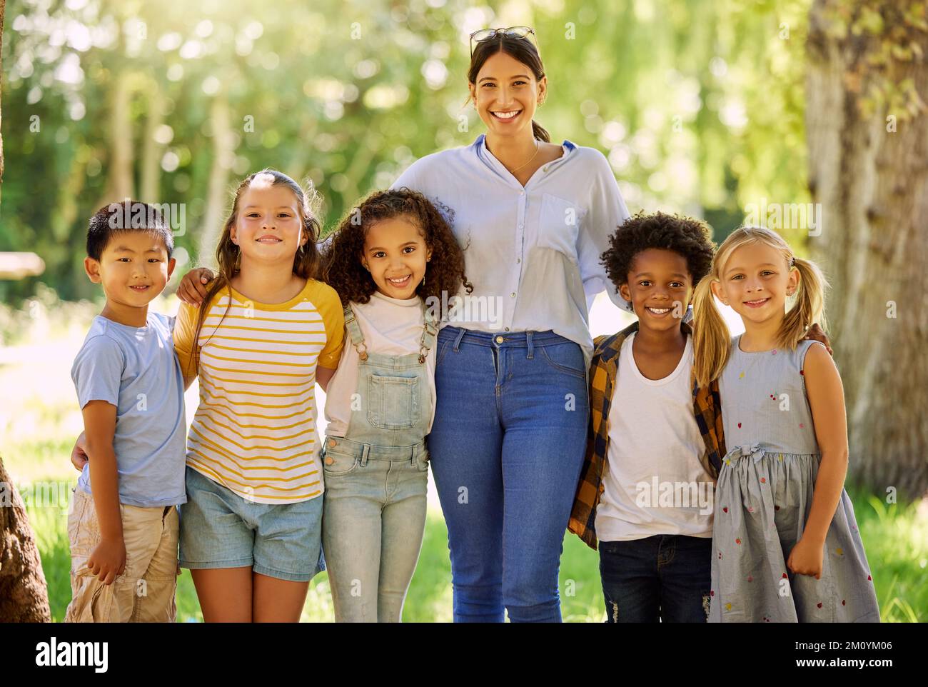 Summer days are super fun days. a group of elementary school children and their teacher together ...