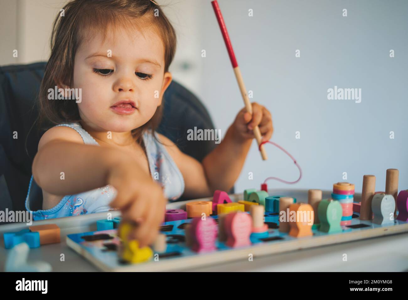 Playful cute little baby girl learning numbers and math with blocks for ...