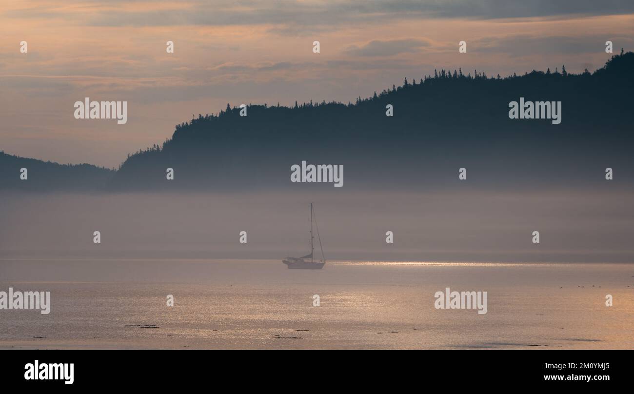 An aerial view of boat floating on water in background of mountains ...