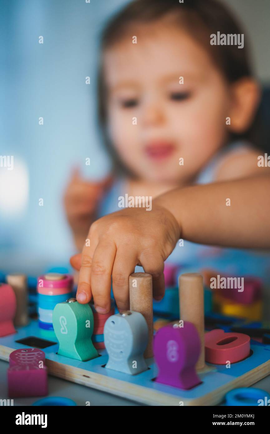 Little baby girl learning numbers and shapes, playing on high-chair at ...