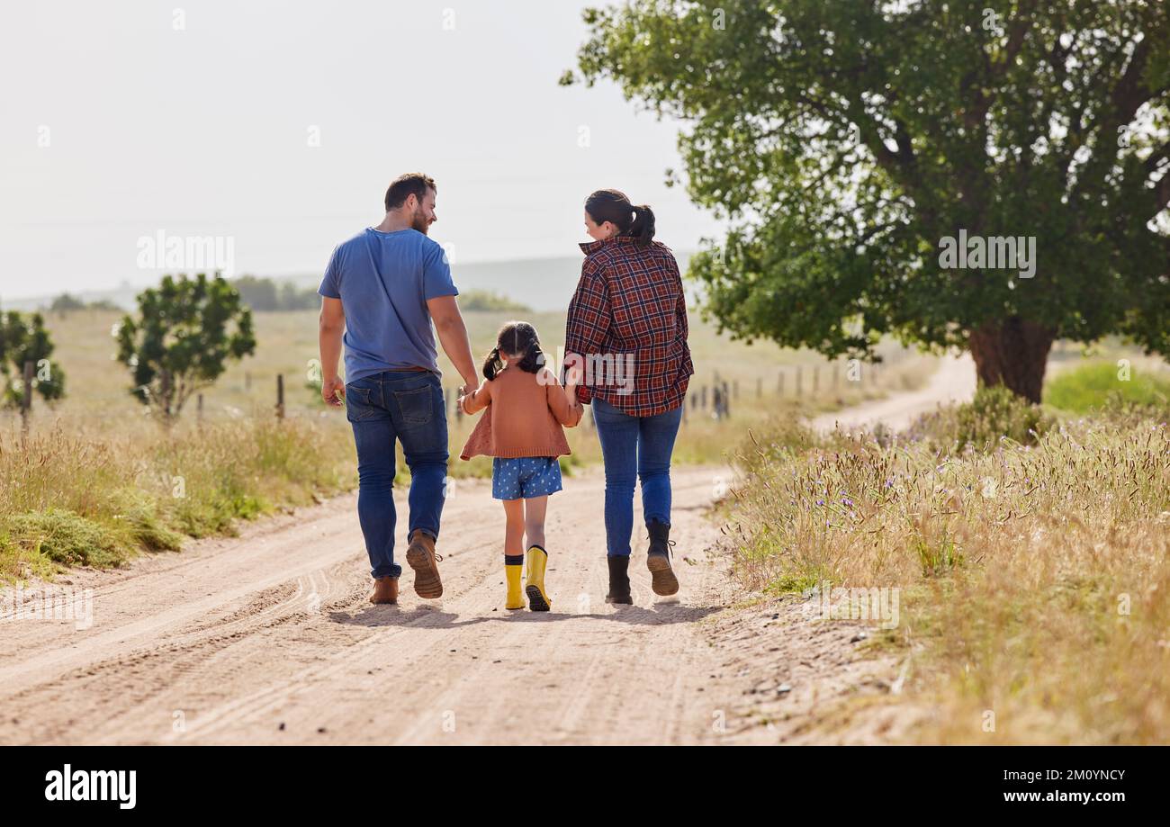 Their life looks pretty idyllic. a little girl walking on a farm with ...