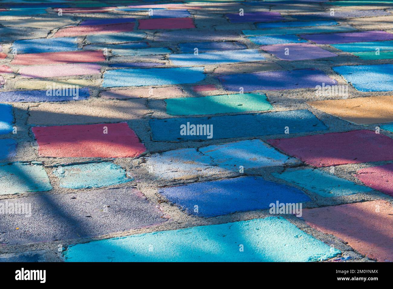 Pattern of shadow and light and colorful concrete tiles in hues of pink ...