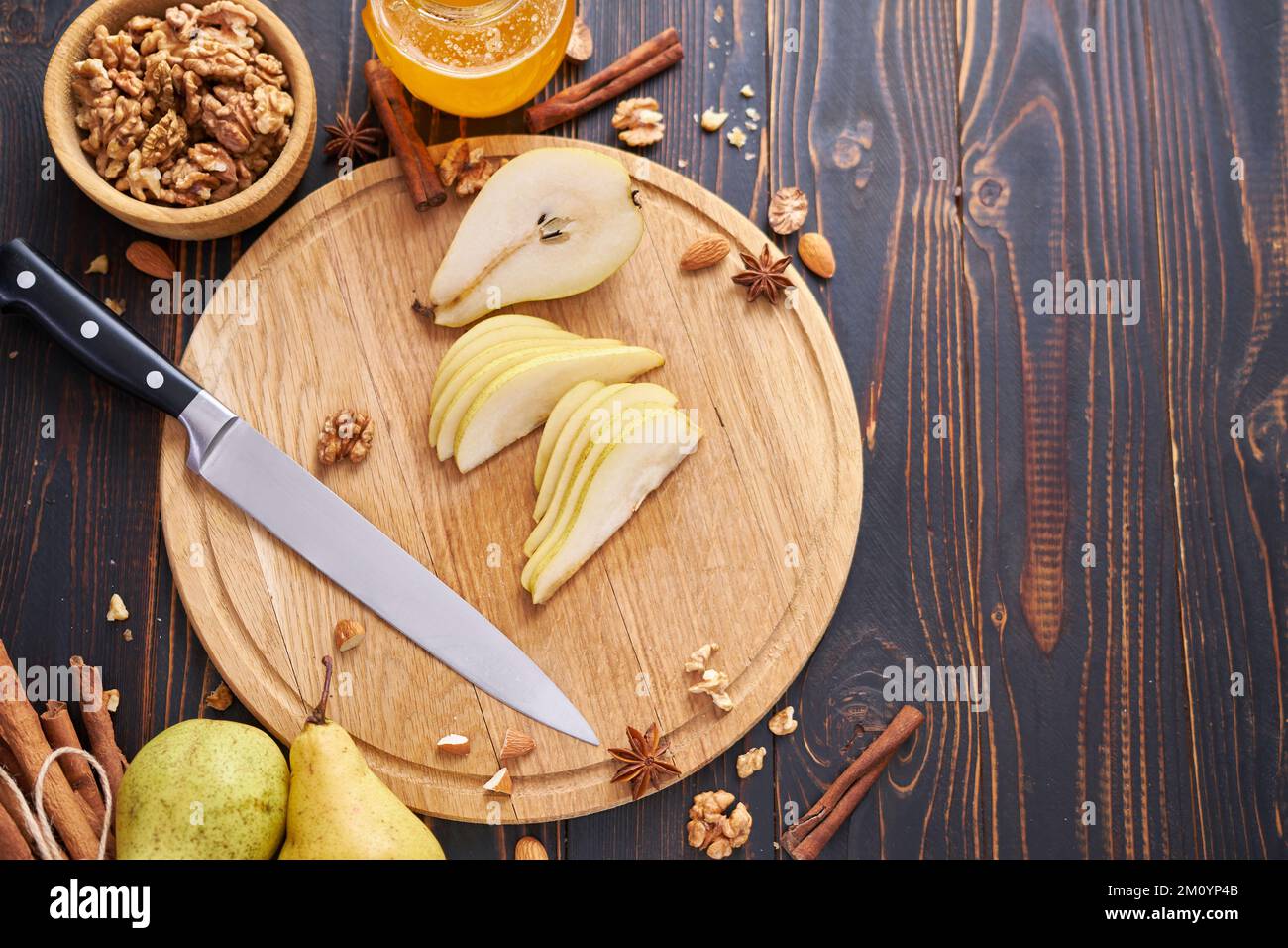 Ripe organic pear on the wooden cutting board Board at domestic kitchen ...