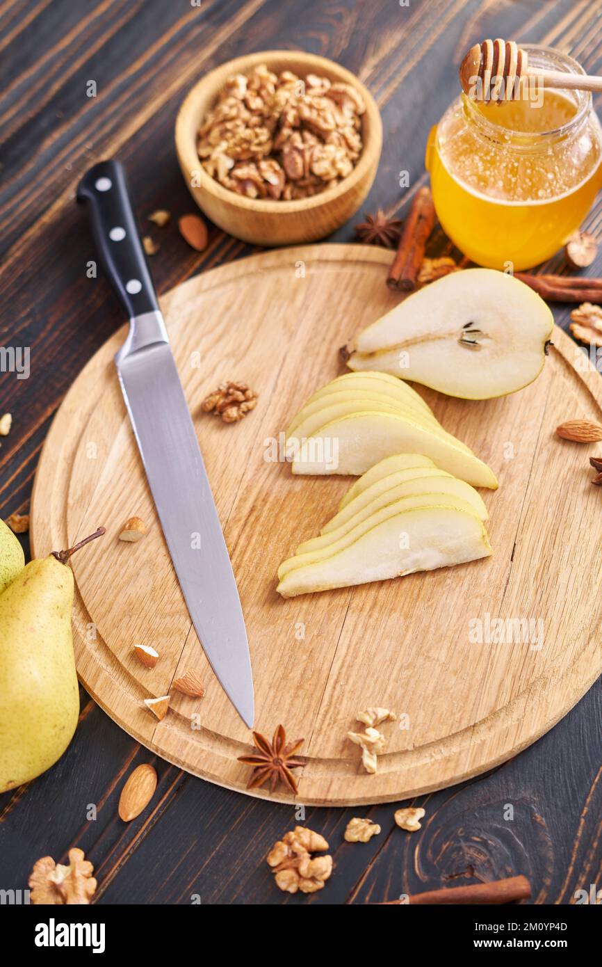 Ripe organic pear on the wooden cutting board Board at domestic kitchen ...