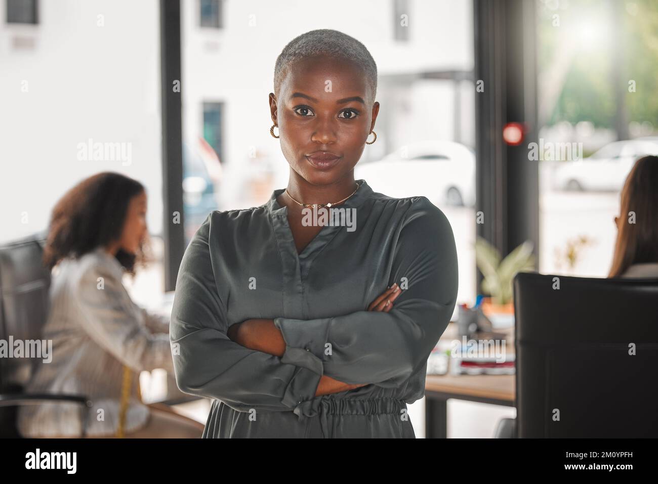 Lets get working. a young businesswoman standing with her arms crossed ...