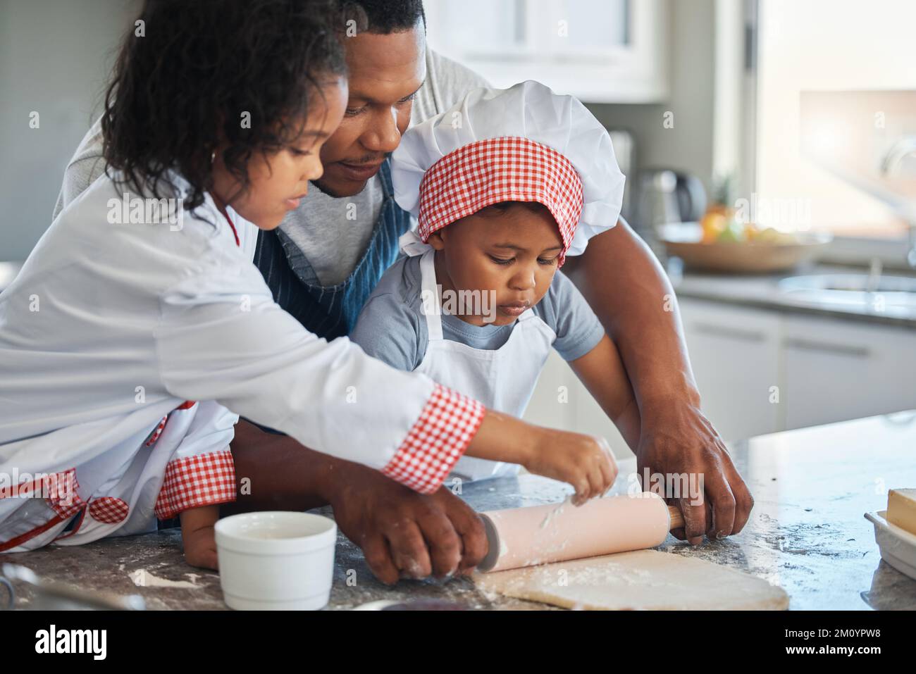 Baking with your children is a benefit in itself. a father baking at ...
