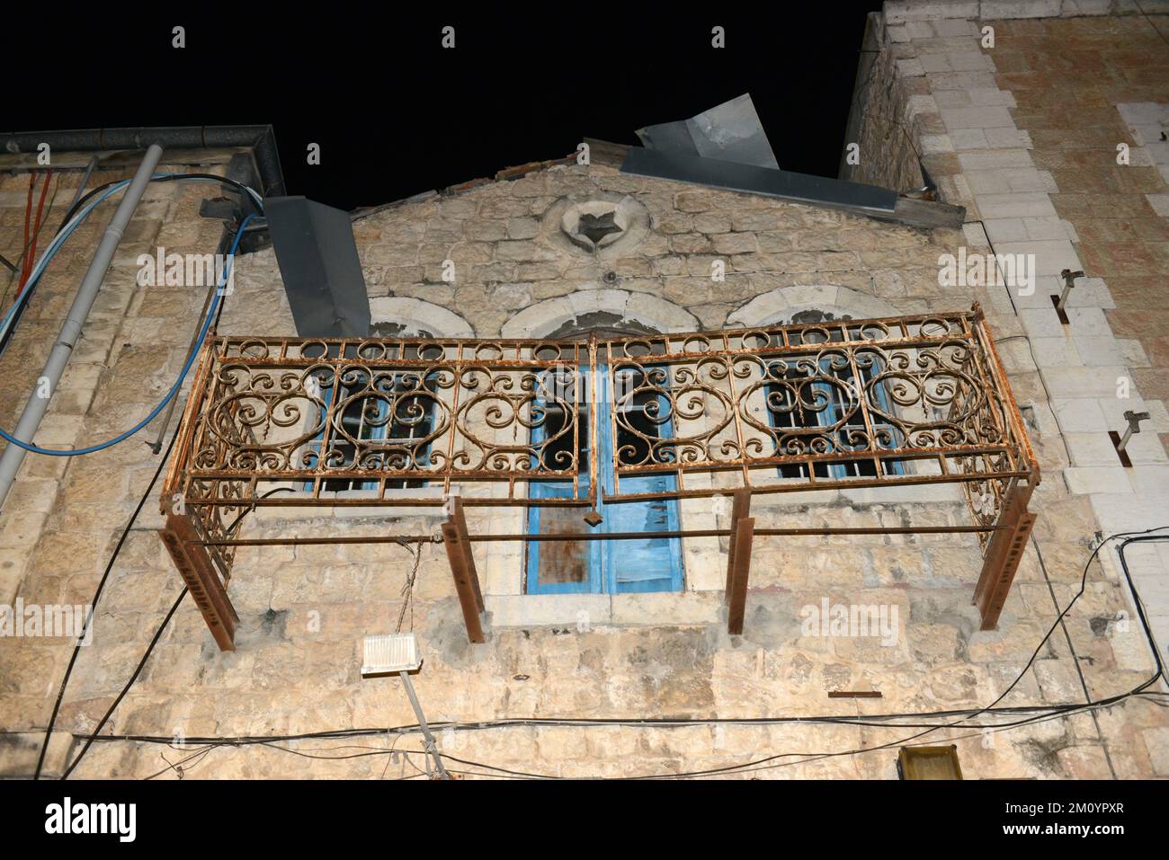 Façade of a beautiful old building with a ruined balcony on Jaffa ...