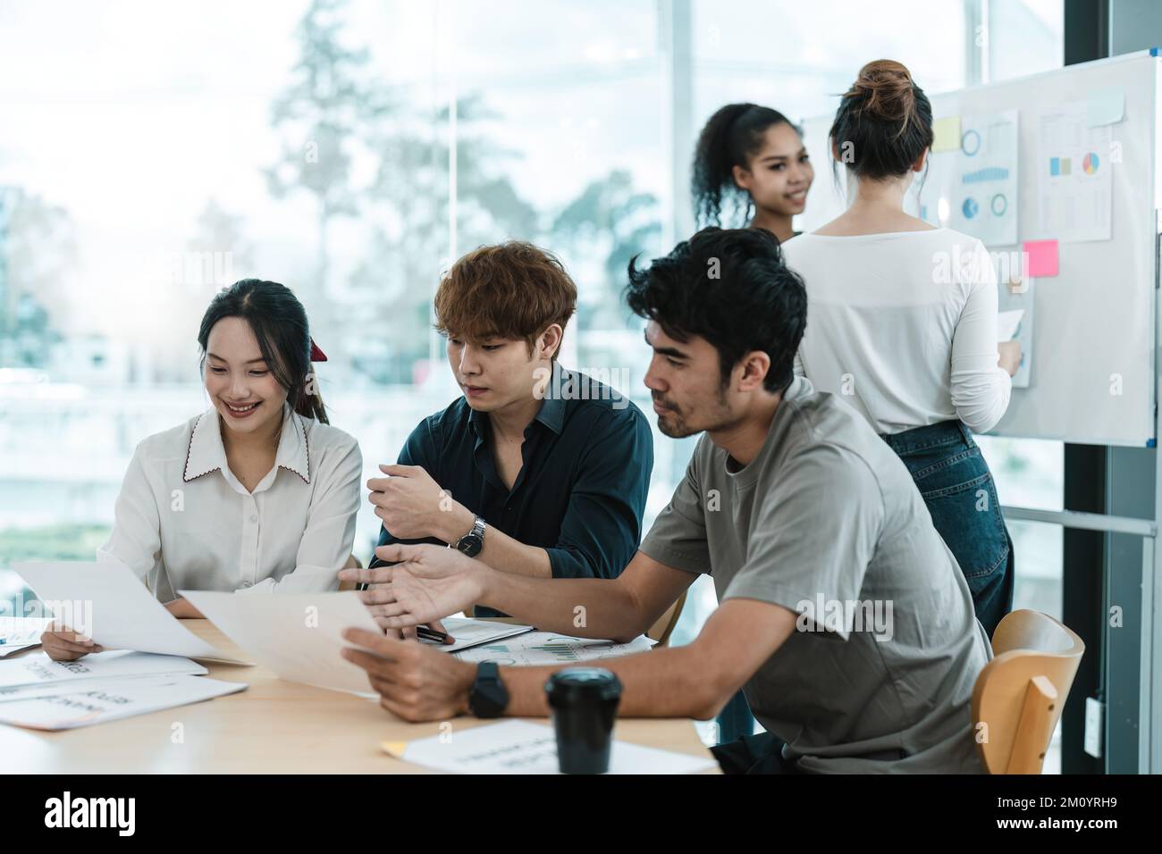 Young asian people having business meeting in office. teamwork brainstorming planning meeting ...
