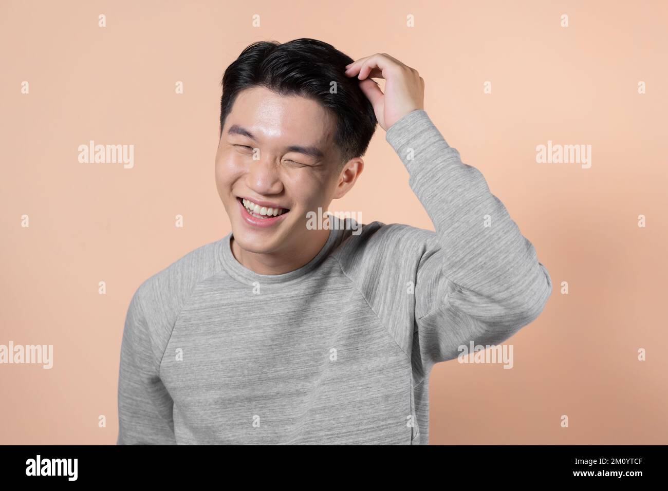 beautiful happy smiling man touching his hair Stock Photo - Alamy