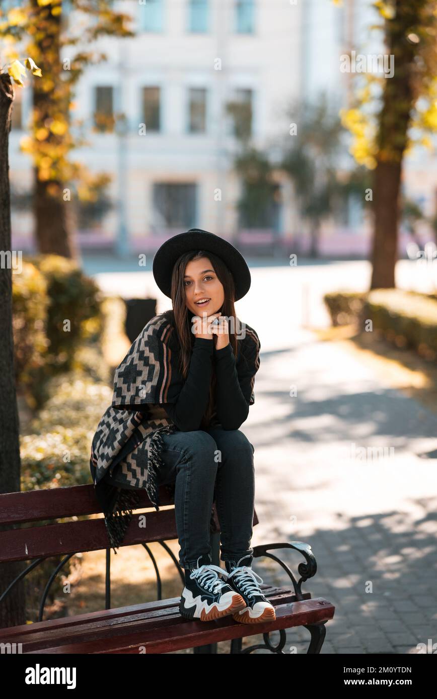 Young woman on a bench in the autumn park Stock Photo - Alamy