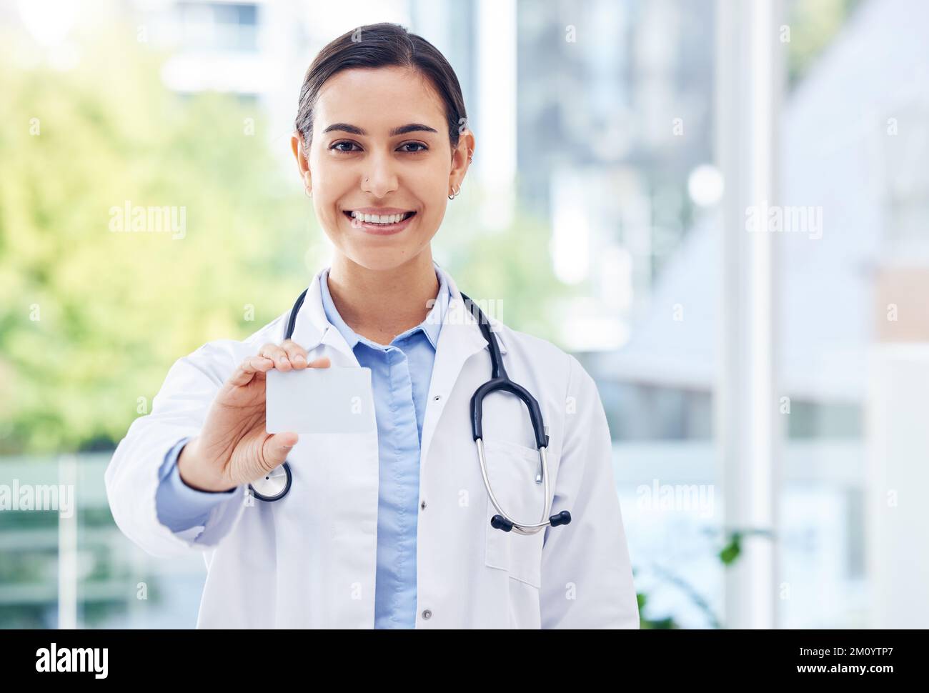 Please do save and share my details. Portrait of a young doctor holding ...