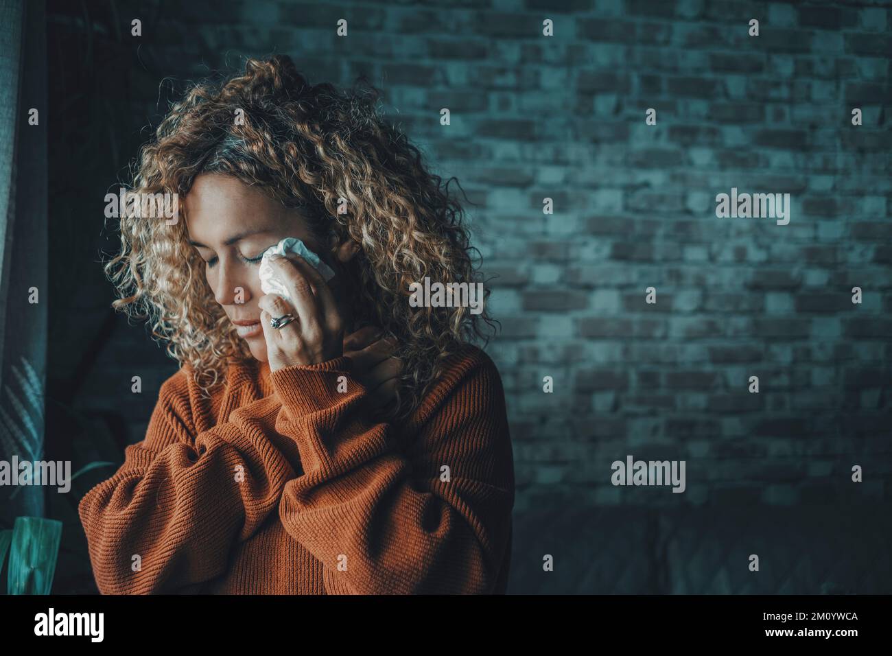 Sad woman alone at home in a dark room and background. Concept of life ...