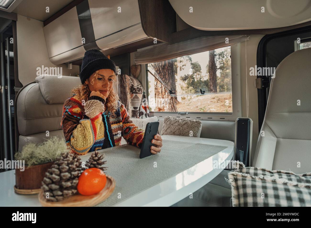 One woman living inside a modern camper van motorhome sitting at the ...