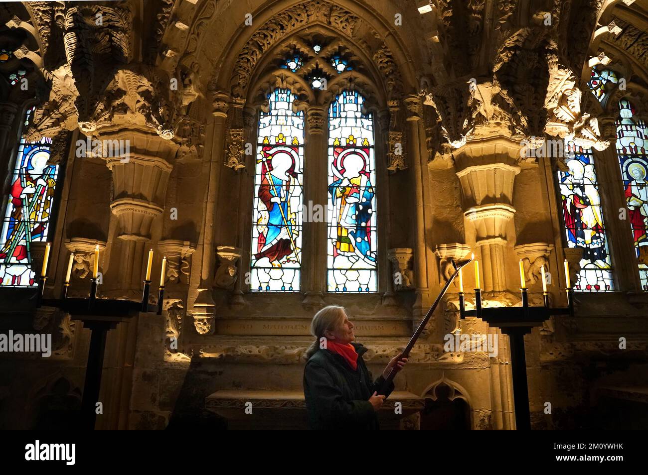Chapel guide Maureen Moffat lights candles as she prepares for a series ...