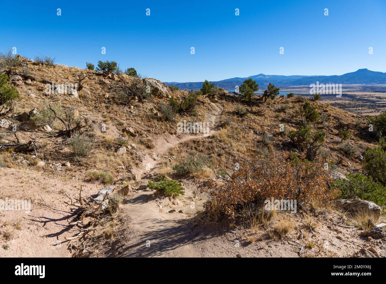Chimney Rock hiking trail through desert towards distant mountains at ...