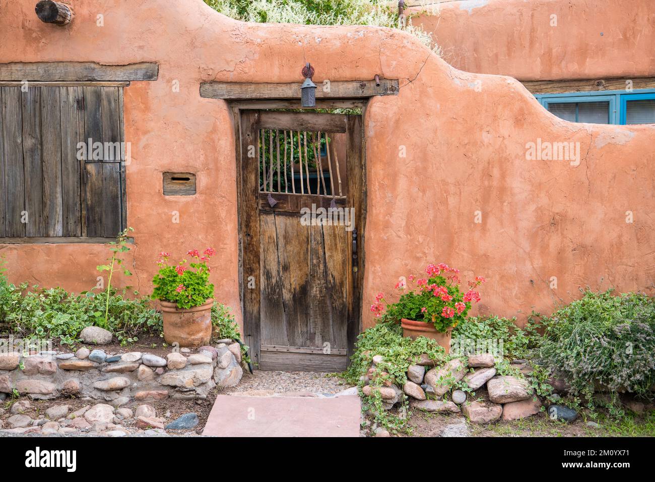 Rustic wood door set in old adobe wall in Santa Fe, New Mexico Stock ...