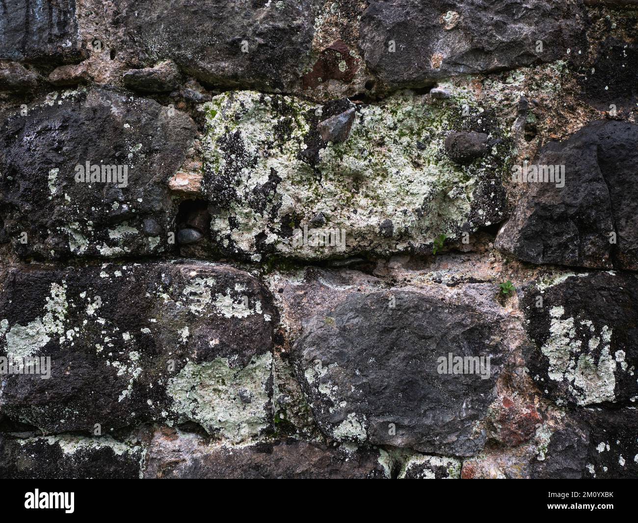 Texture of old black and grey masonry stone wall. Ancient grunge brick ...