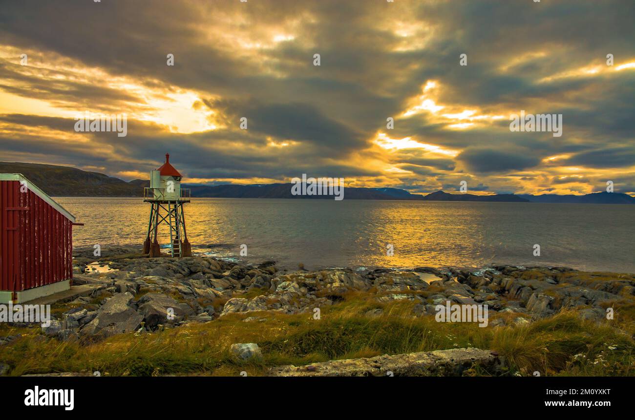 the Fuglenes lighthouse in Norway, on the background of the sunrise ...