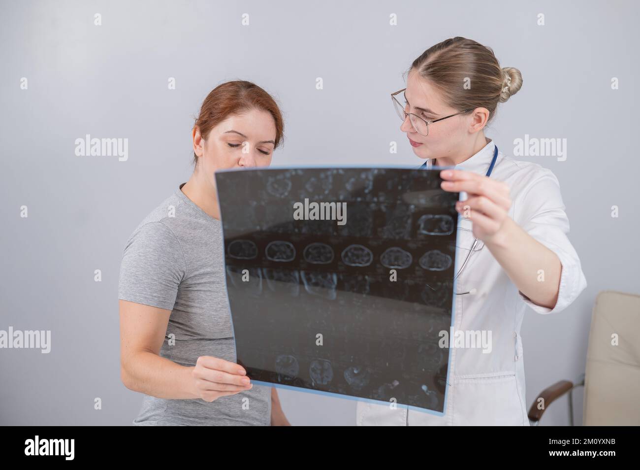 Female doctor explaining mri of internal organs to female patient Stock ...