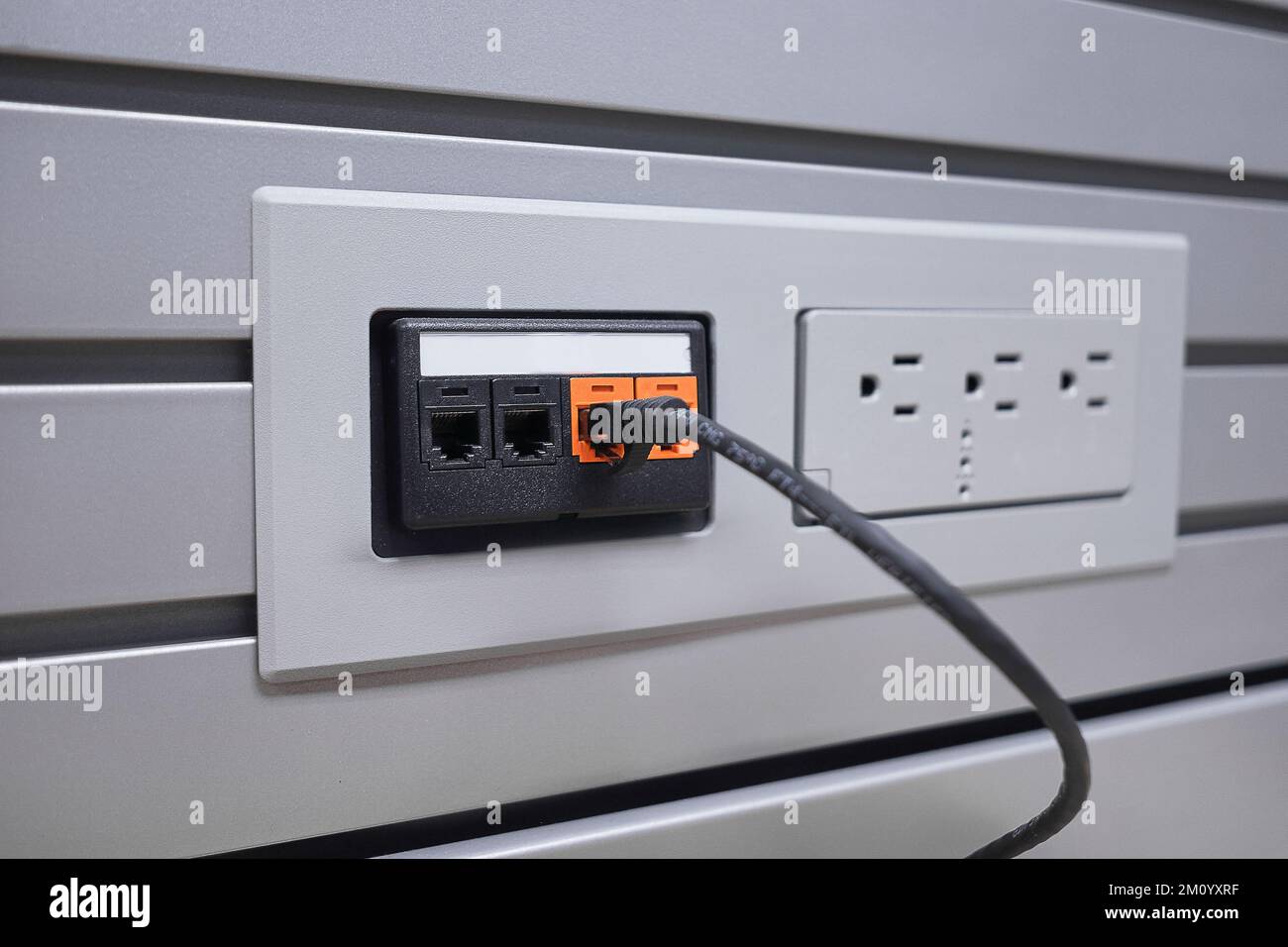 Ethernet cable plugged into wall socket. 4 socks two black two orange ...