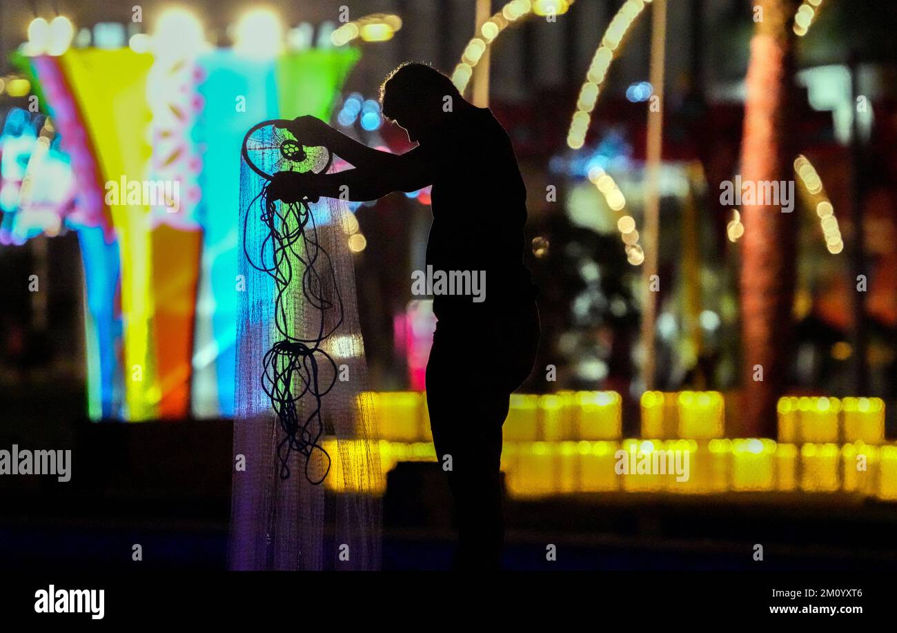 A man fishing in the Persian Gulf waters at the Corniche in Doha, Qatar ...