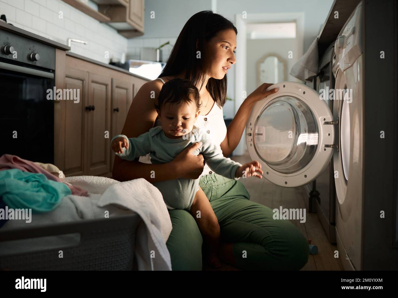 Someone pooped all over our bedding...a mom doing laundry at night with her baby on her arm ...