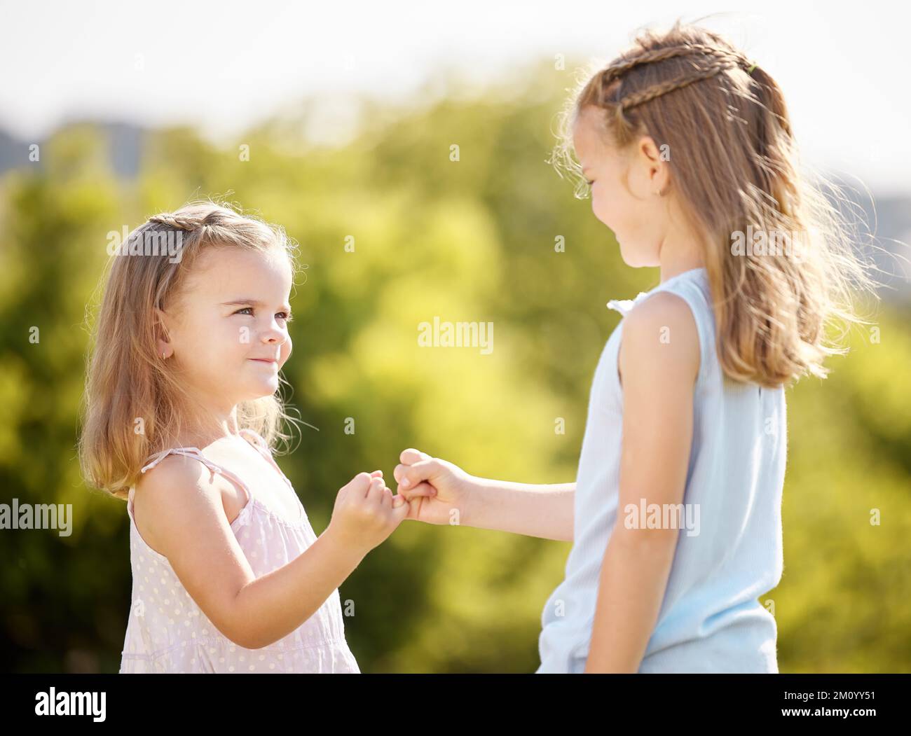 I got your back. two adorable little girls having fun in a park Stock ...