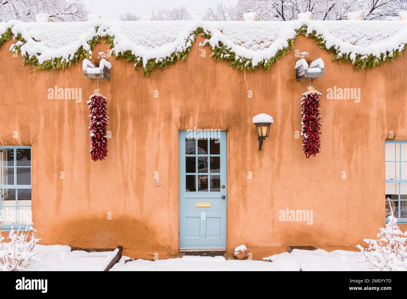 Christmas scene in Santa Fe, New Mexico, snow-covered adobe building ...
