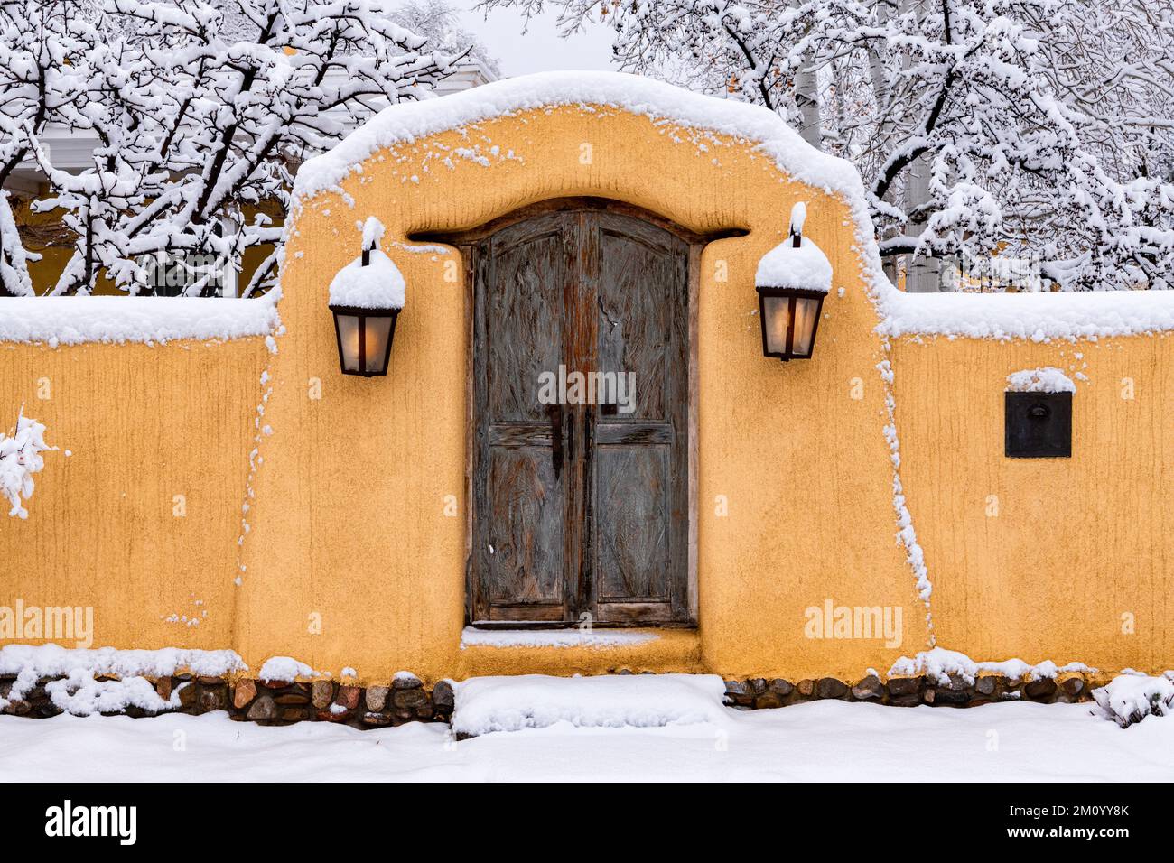 Winter in Santa Fe, New Mexico - snow-covered adobe wall with rustic ...