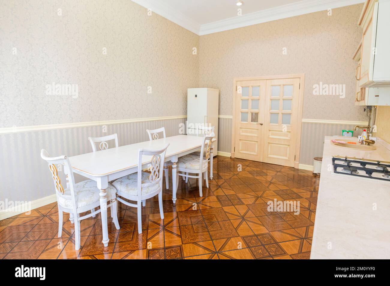 Large bright kitchen with high ceiling and linoleum flooring on the ...