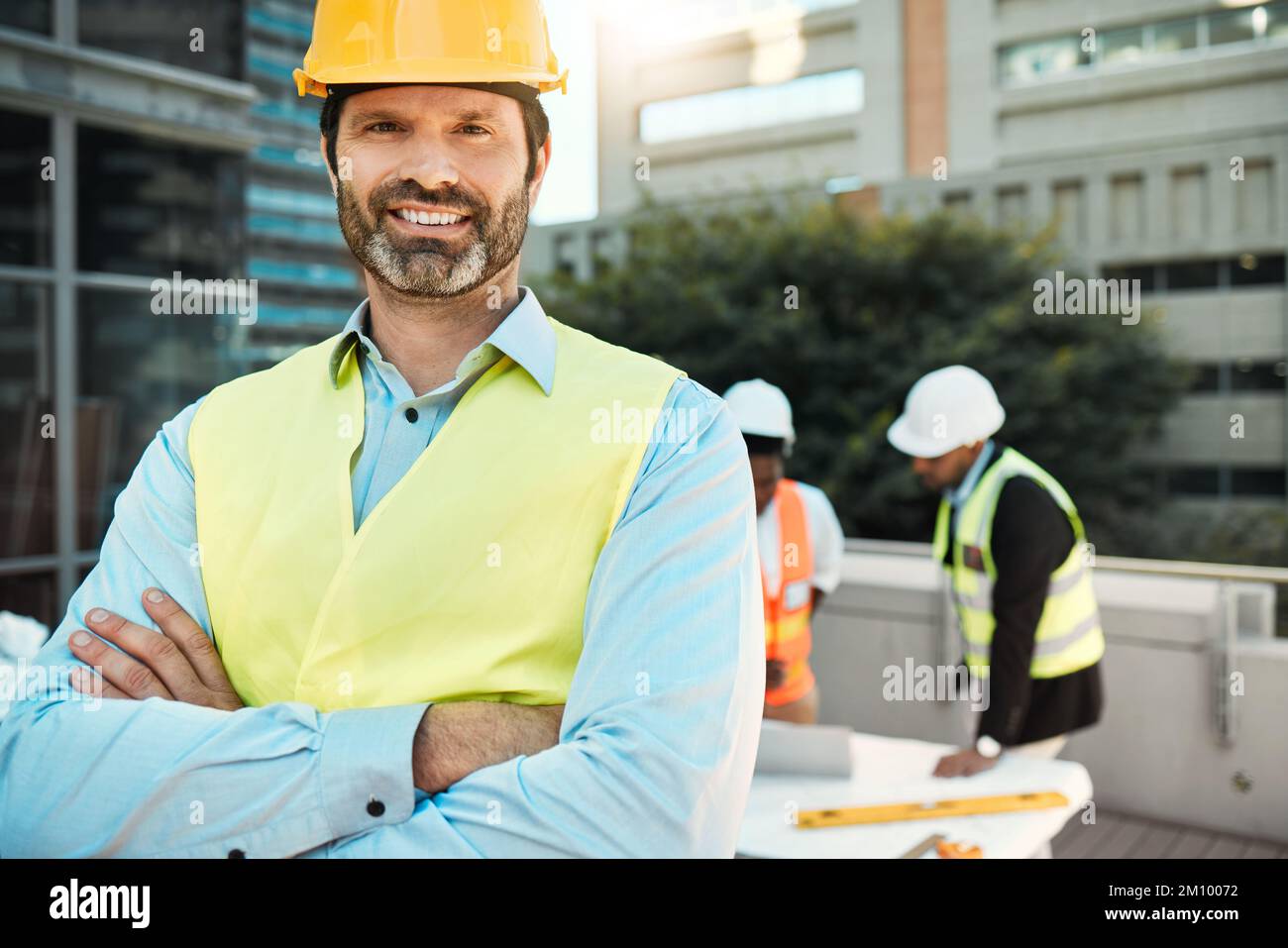 My team are capable of anything. a mature contractor standing outside ...