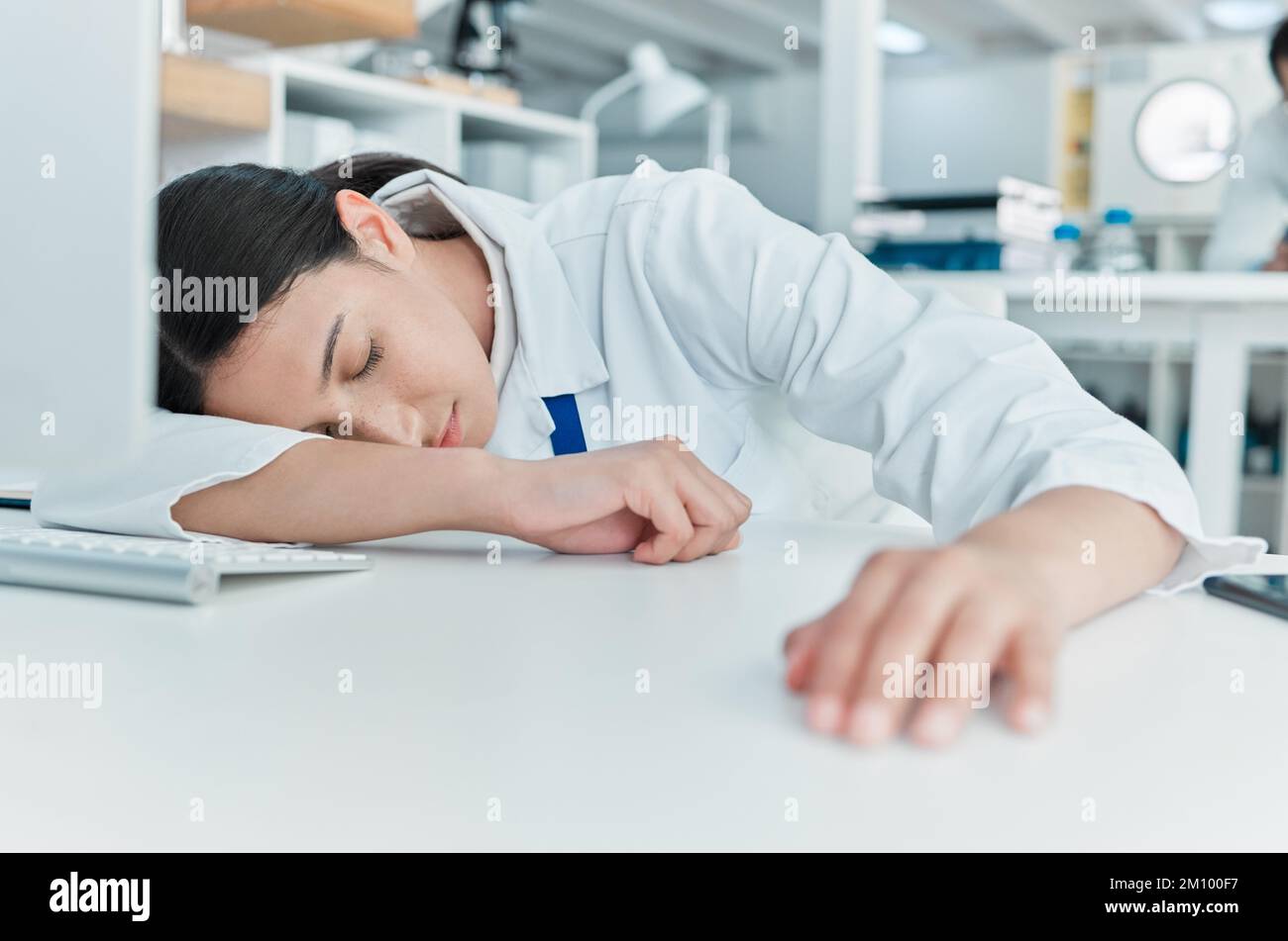Change of plans - I give up. a young scientist sleeping at a desk in a ...