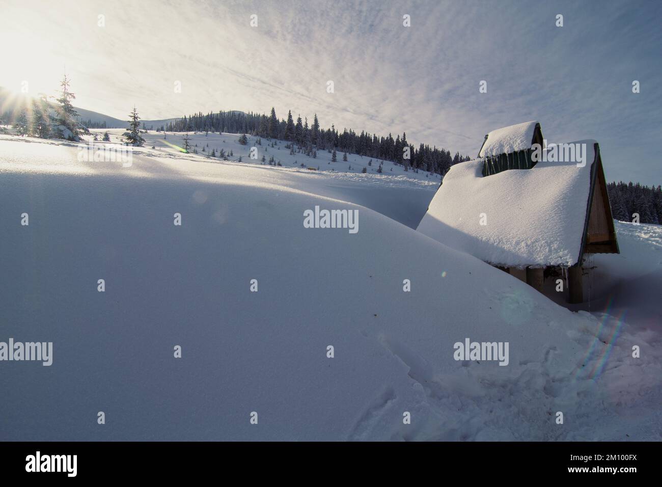 Snow capped cottage on hill landscape photo Stock Photo - Alamy