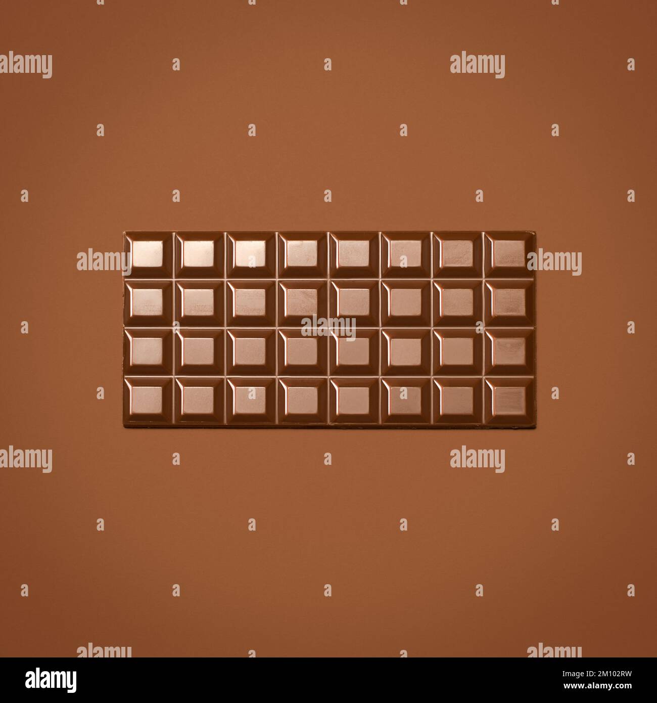 Everyone deserves a little treat. a slab of chocolate against a studio ...