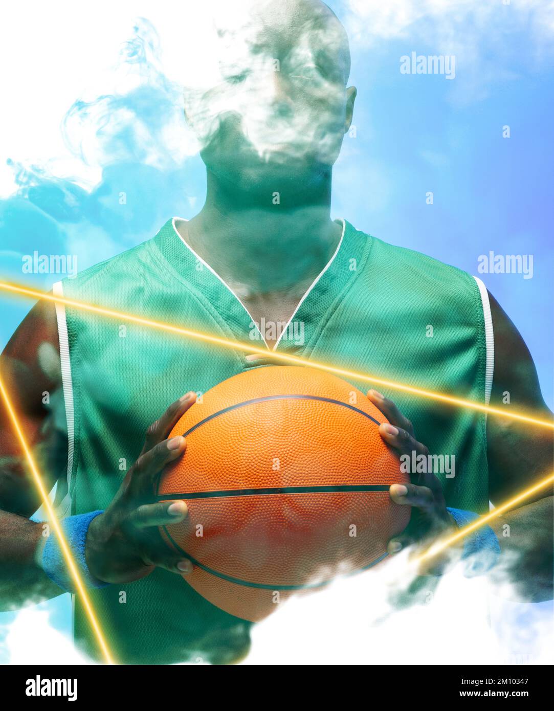 African american basketball player holding ball by illuminated triangle ...