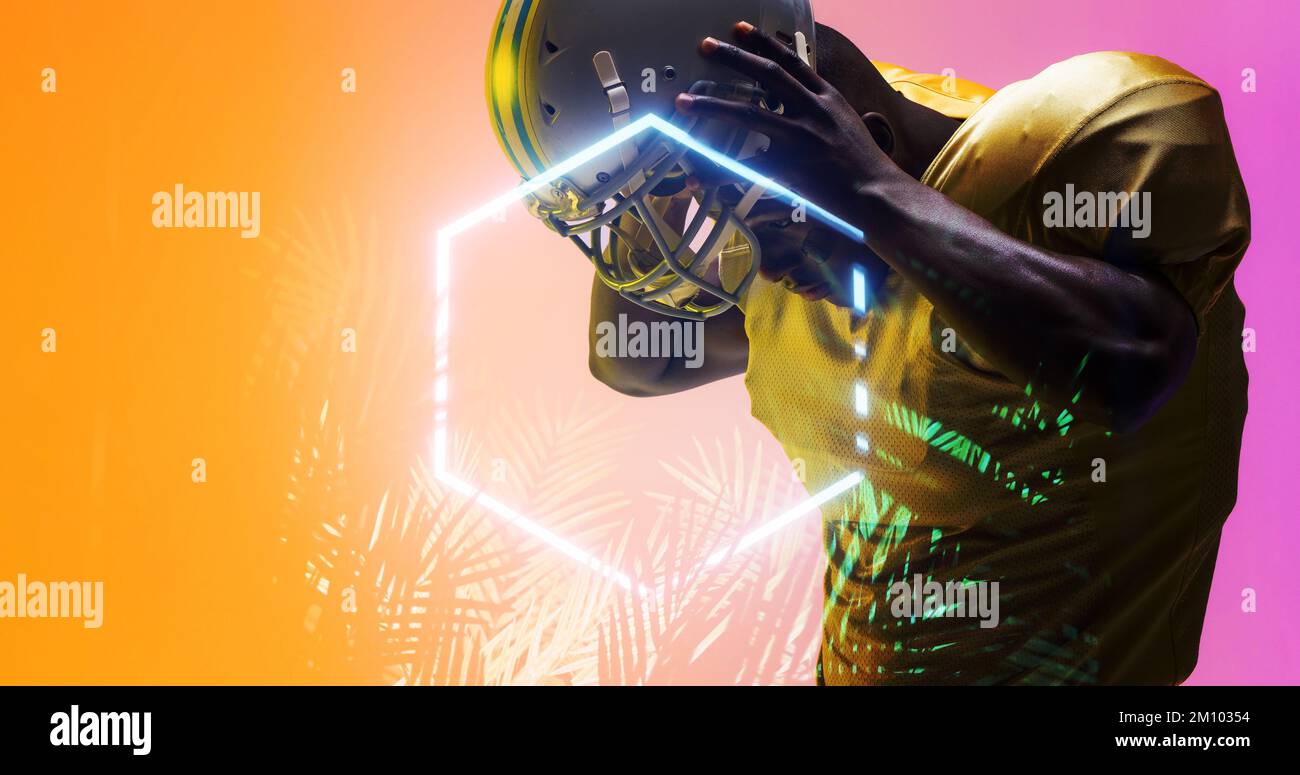 Composite of american football player removing helmet by illuminated ...