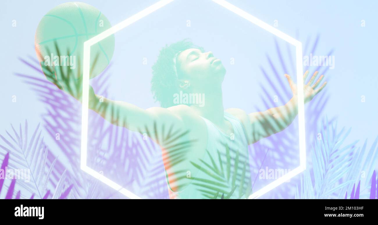 Biracial basketball player with arms outstretched and eyes closed by ...