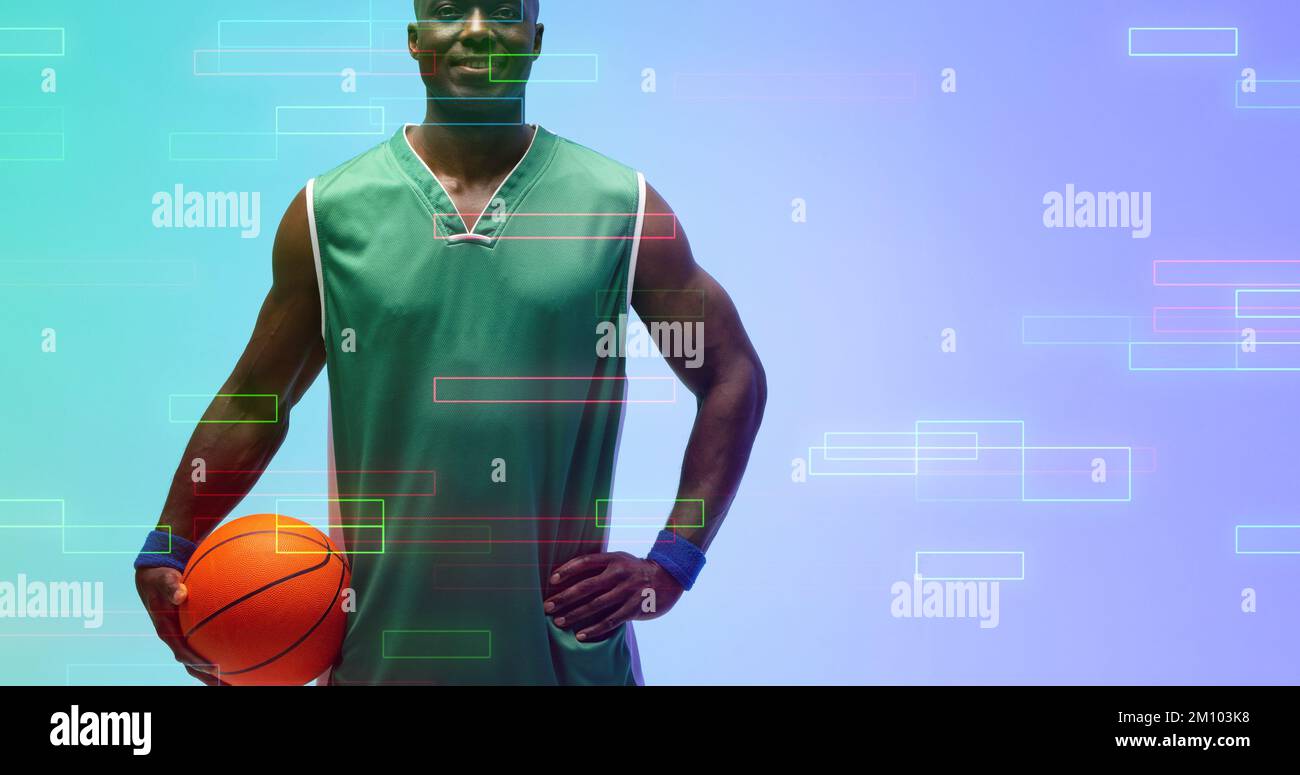 Happy african american basketball player holding ball with illuminated ...