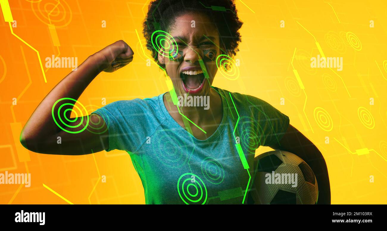 Biracial female soccer player with brazilian flag's face paint ...
