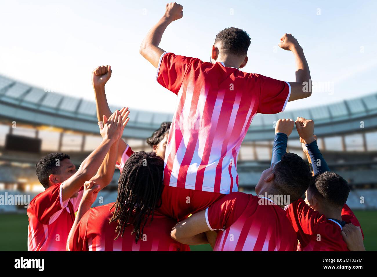 Team of multiracial male players in sports clothing celebrating success ...