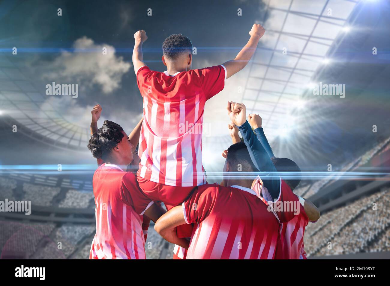 Team of multiracial soccer players celebrating victory in stadium on ...